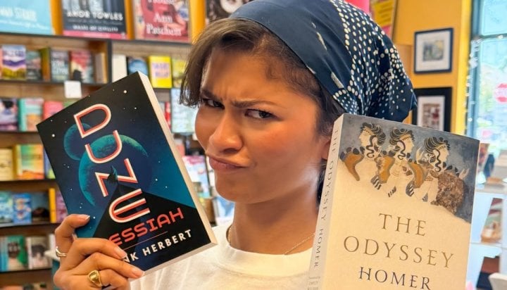Zendaya poses with books linked to her and Tom Holland’s upcoming movies