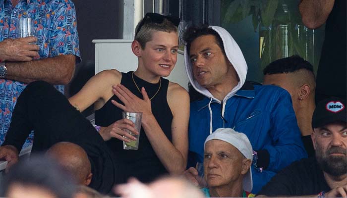 Rami Malek and Emma Corrin confirm romance by kissing in public ...